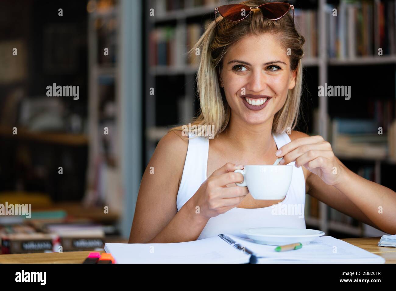 Education, study and home concept. Happy smiling student girl studying ...