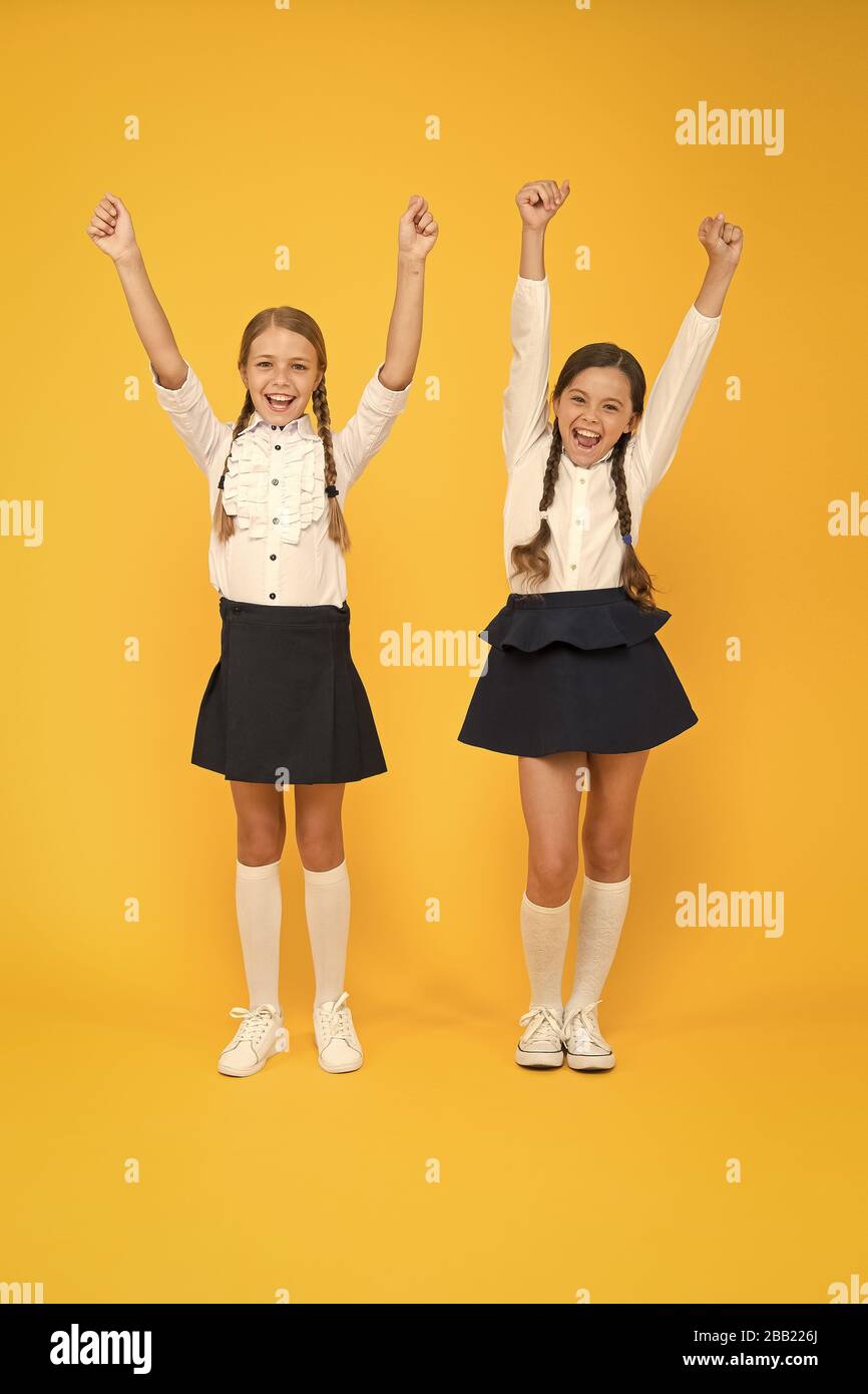 Celebrating back to school. Happy girls celebrating achievement in ...