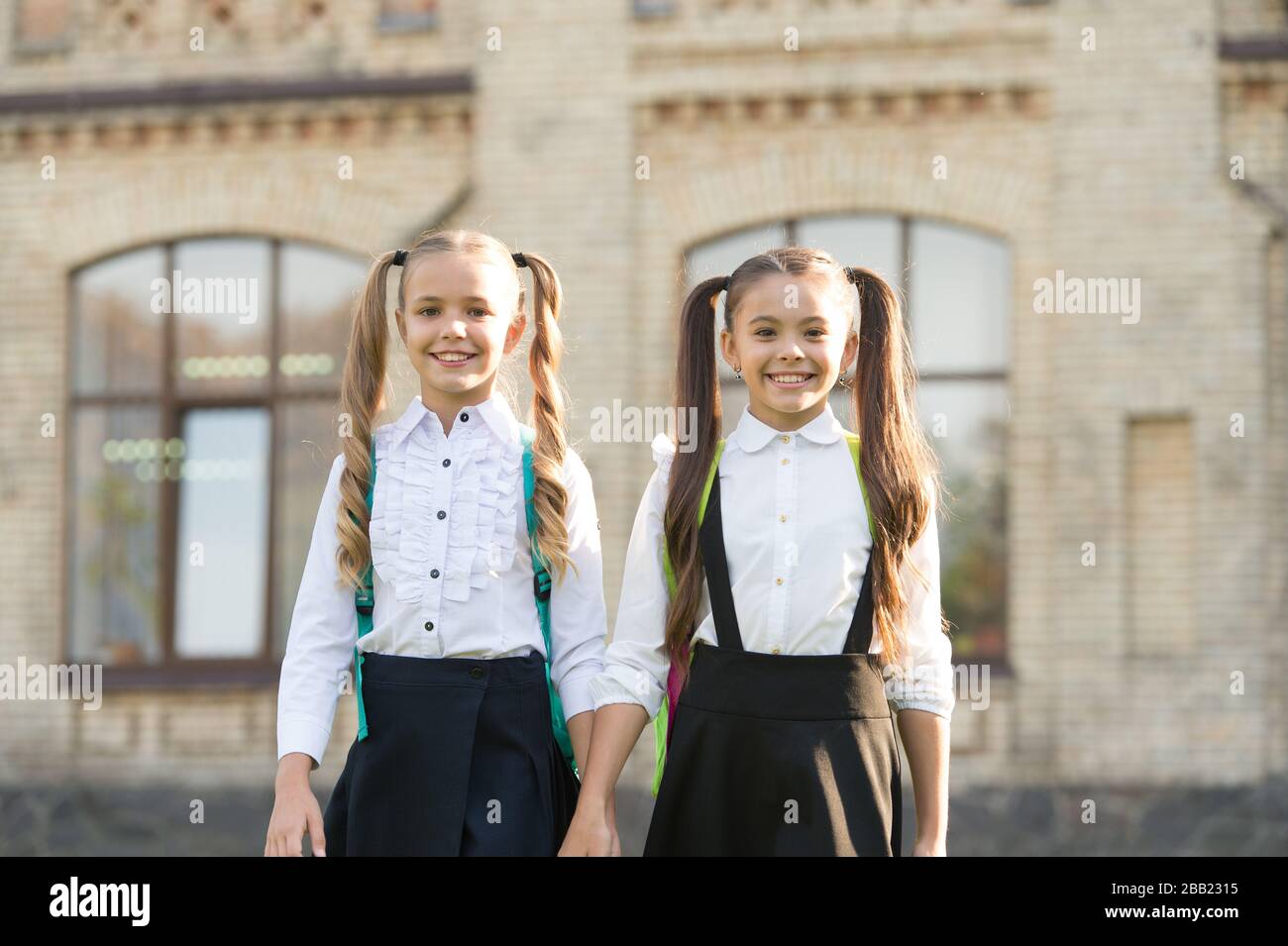 Lucky to meet each other. Cheerful smart schoolgirls. Happy schoolgirls ...