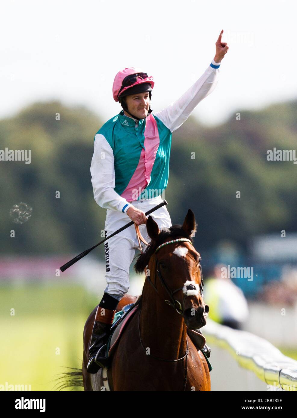 Tom Queally onboard Frankel celebrates on his parade past the ...