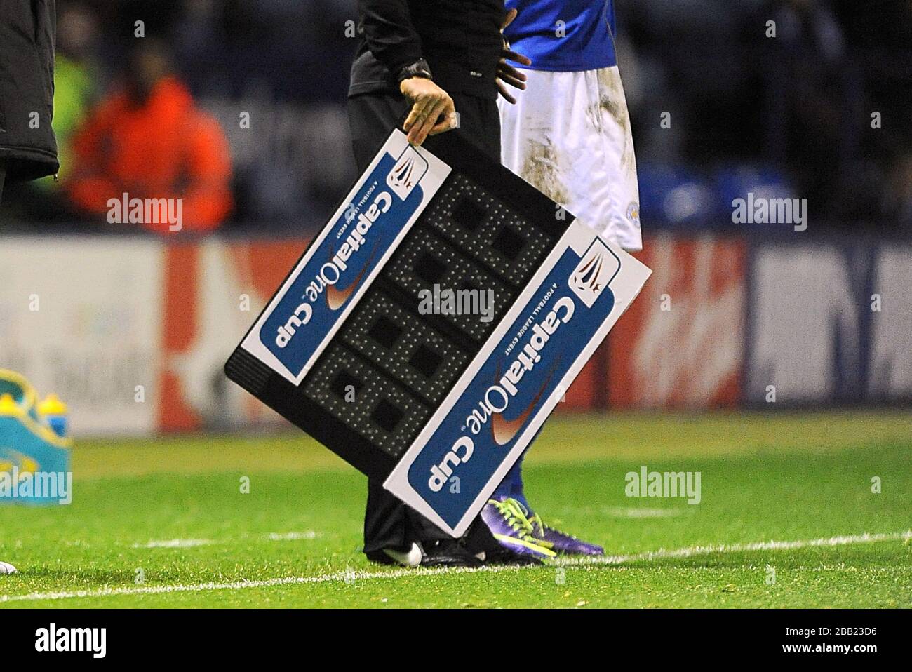 The fourth official holds an electronic board with Capital One Cup ...