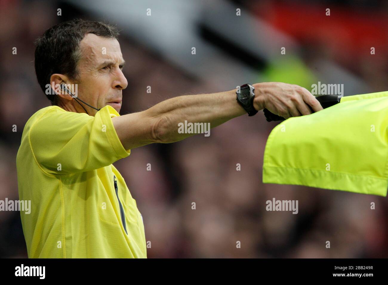 The assistant referee raises his flag hi-res stock photography and ...