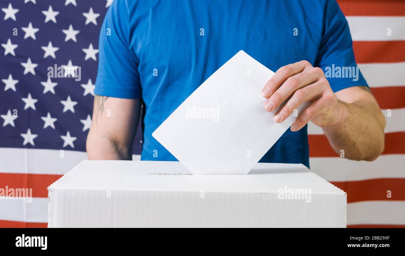 Persons Hand with ballot and voting box on Flag of USA Stock Photo - Alamy
