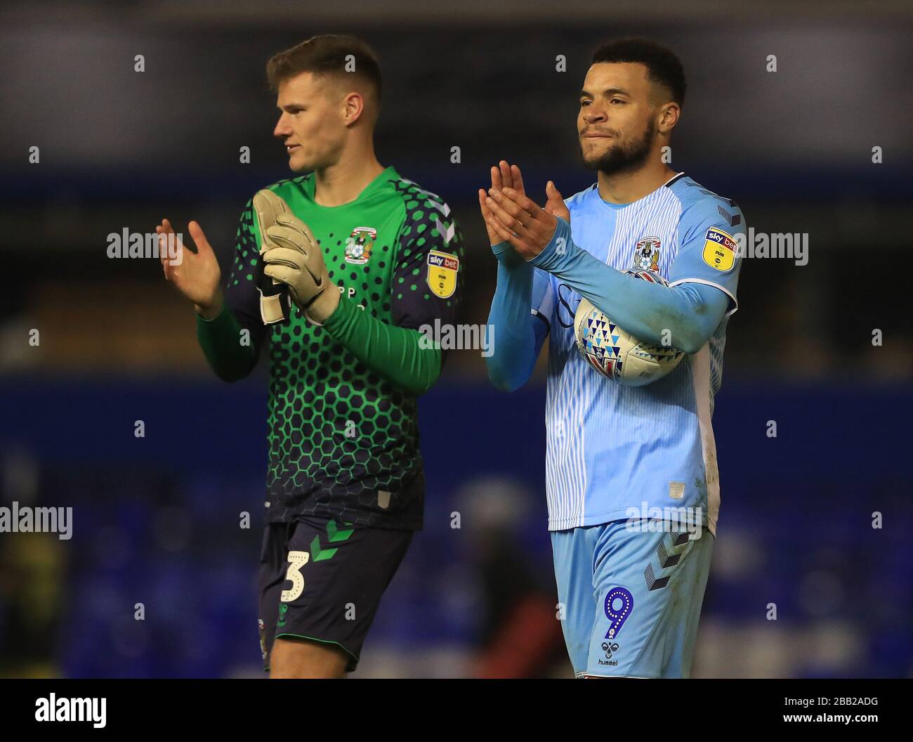 Coventry City's Max Biamou (right) walks off with the match ball after ...
