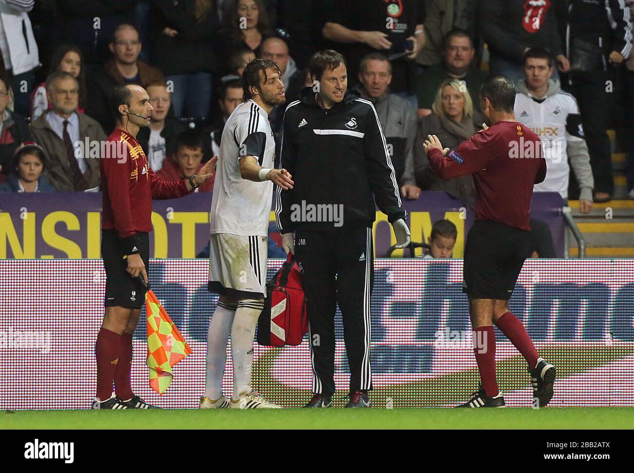 Swansea City's Miguel Michu complains to referee Duarte Gomes (right ...