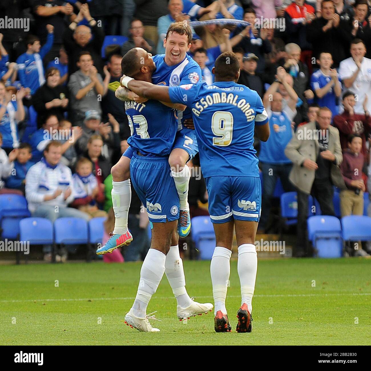 Peterborough United's Danny Swanson jumps into the arms of goalscorer ...