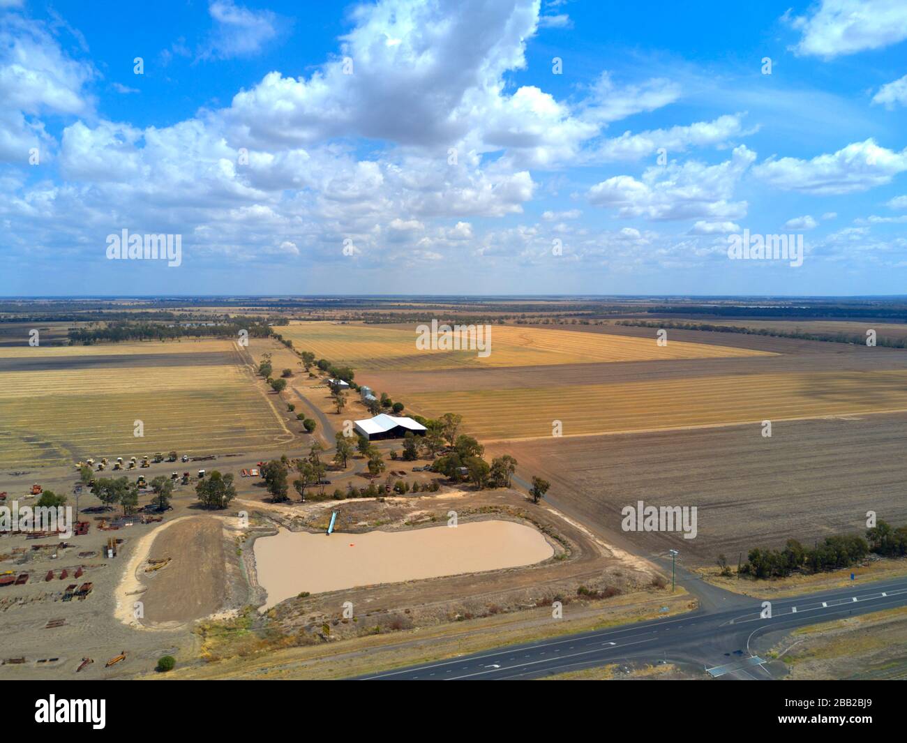 Aerial of large earth dam storing water on a farming property near ...