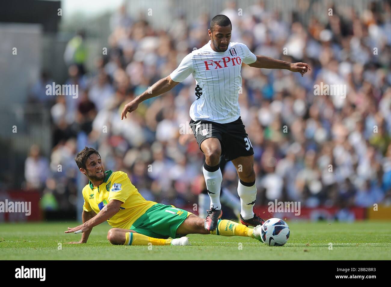 Norwich City's Andrew Surman (left) and Fulham's Moussa Dembele battle ...
