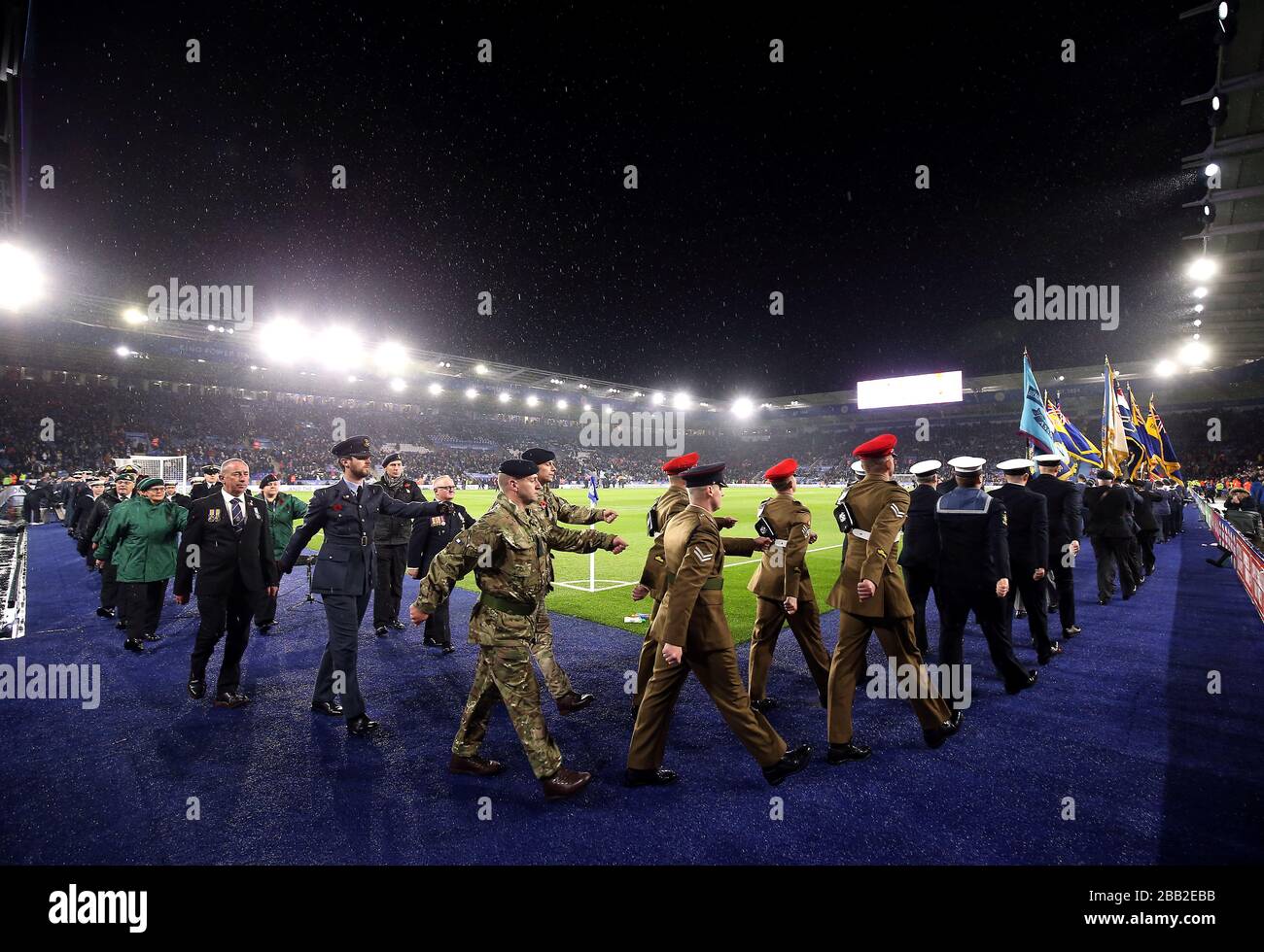 An Armed forces band performs as it marches around the pitch at half ...