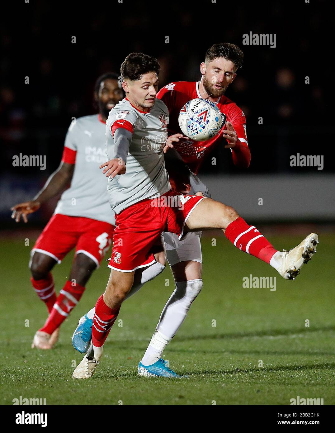 Swindon Town's Rob Hunt battles for the ball with Salford City's Joey ...