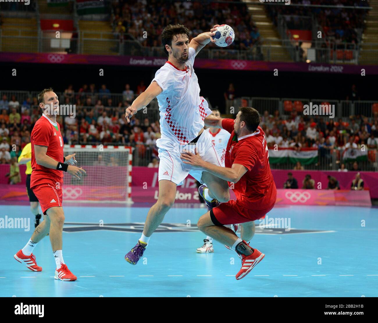 Croatia's Igor Vori shoots as he is tackled by Hungary's Ferenc Ilyes ...