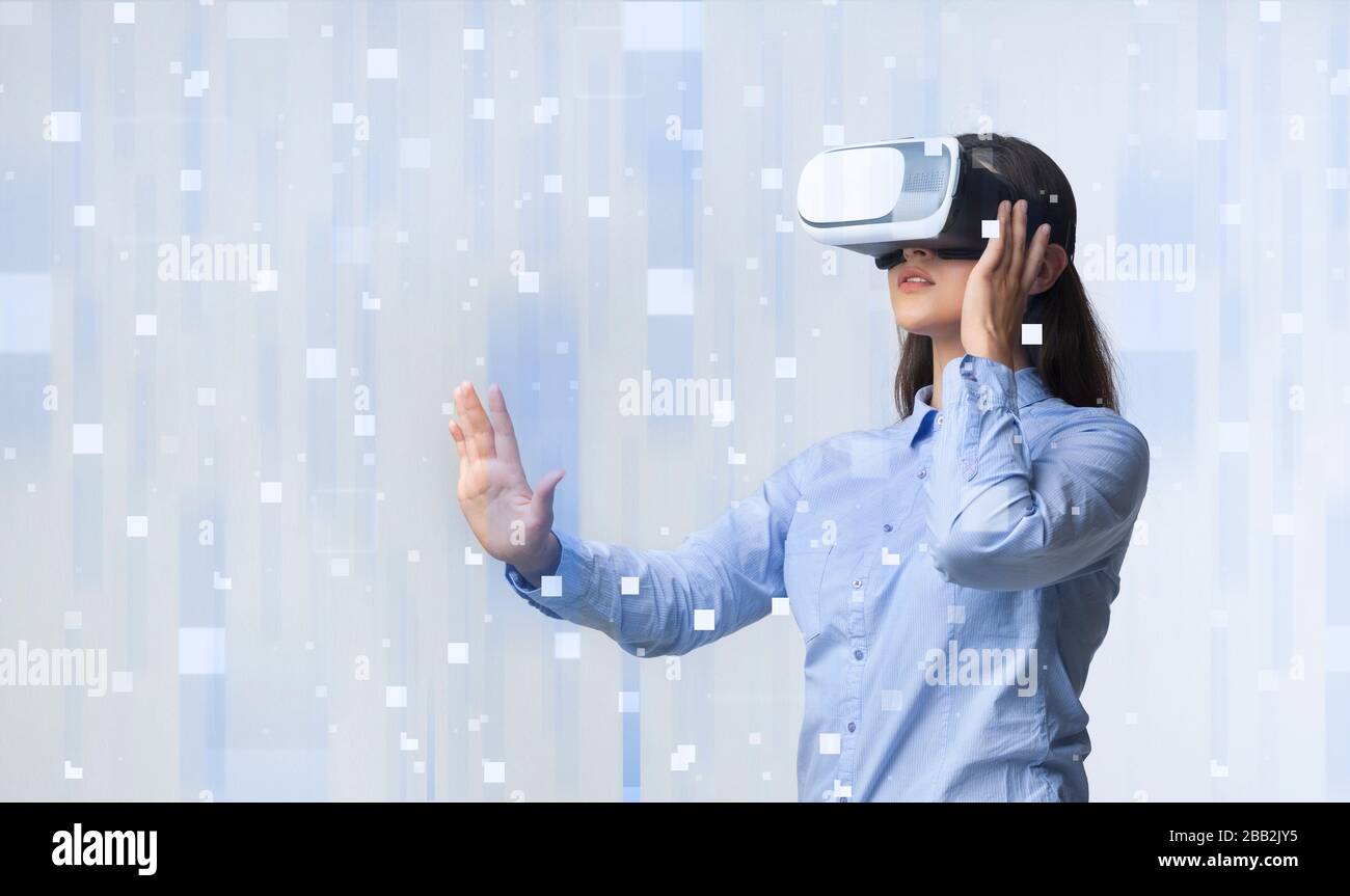Young lady using VR headset on pixelated cyberspace background, blank ...