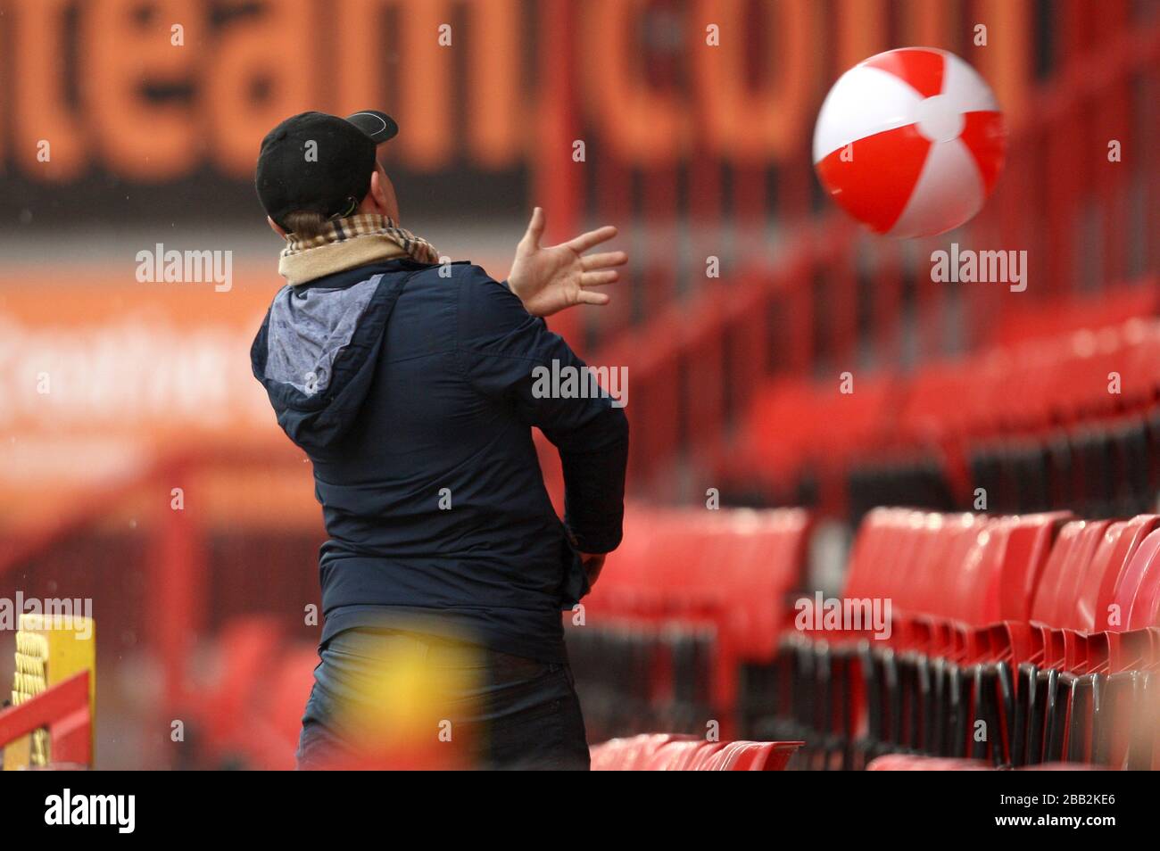 A fan throws a beach ball in the stands before they game Stock Photo ...