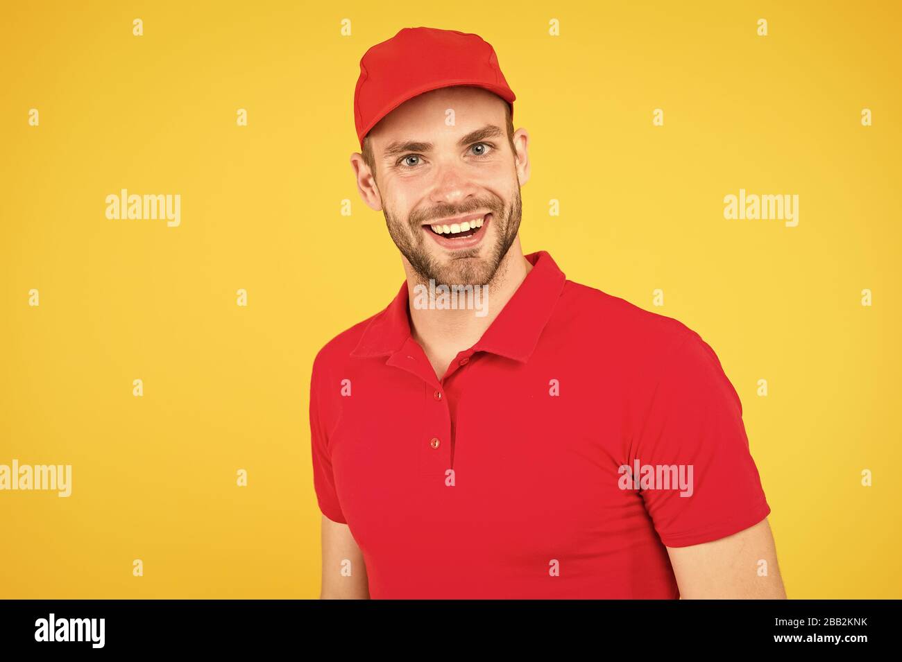 Supermarket cashier. Man delivery service wear red cap. Shop assistant ...