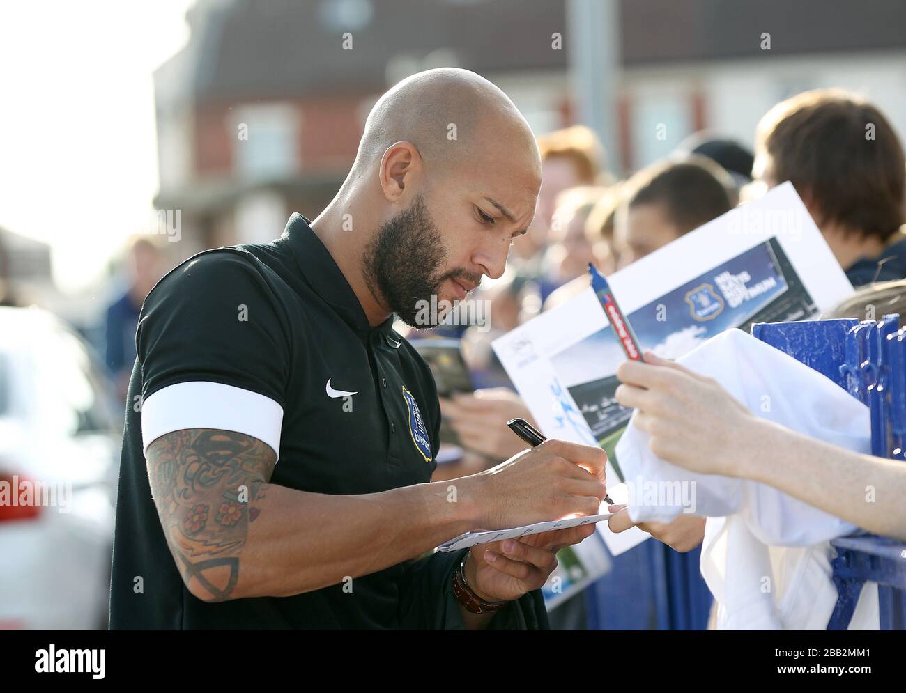 Everton goalkeeper Tim Howard signs autographs for fans Stock Photo - Alamy