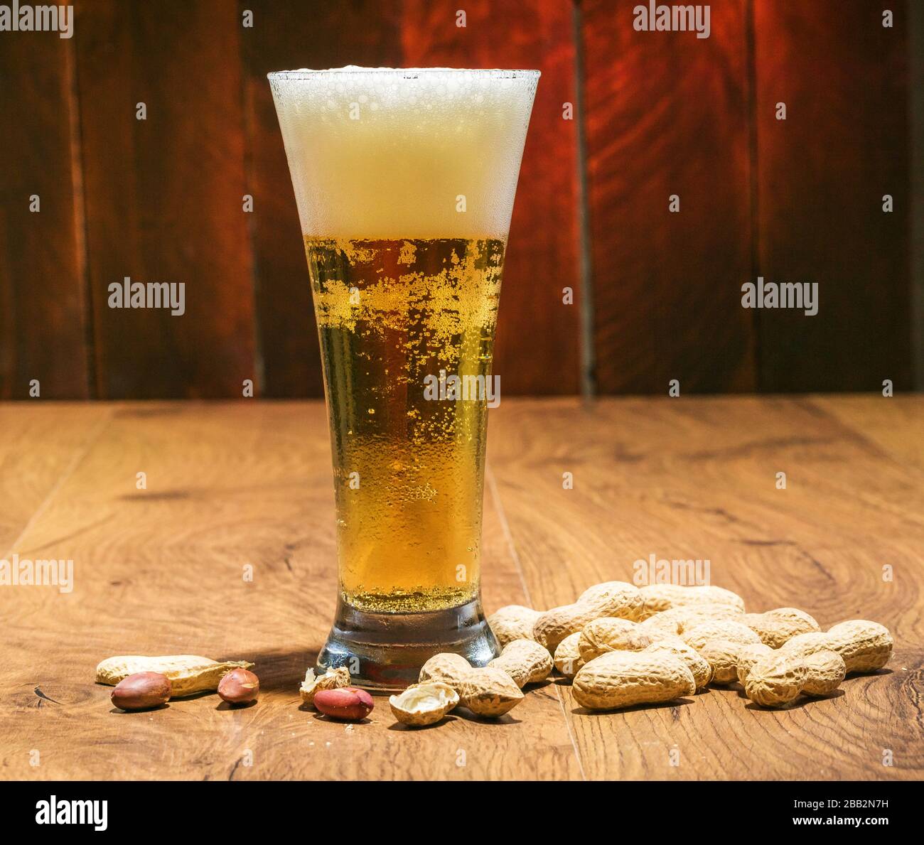A glass of light beer with peanuts was photographed in the studio Stock ...