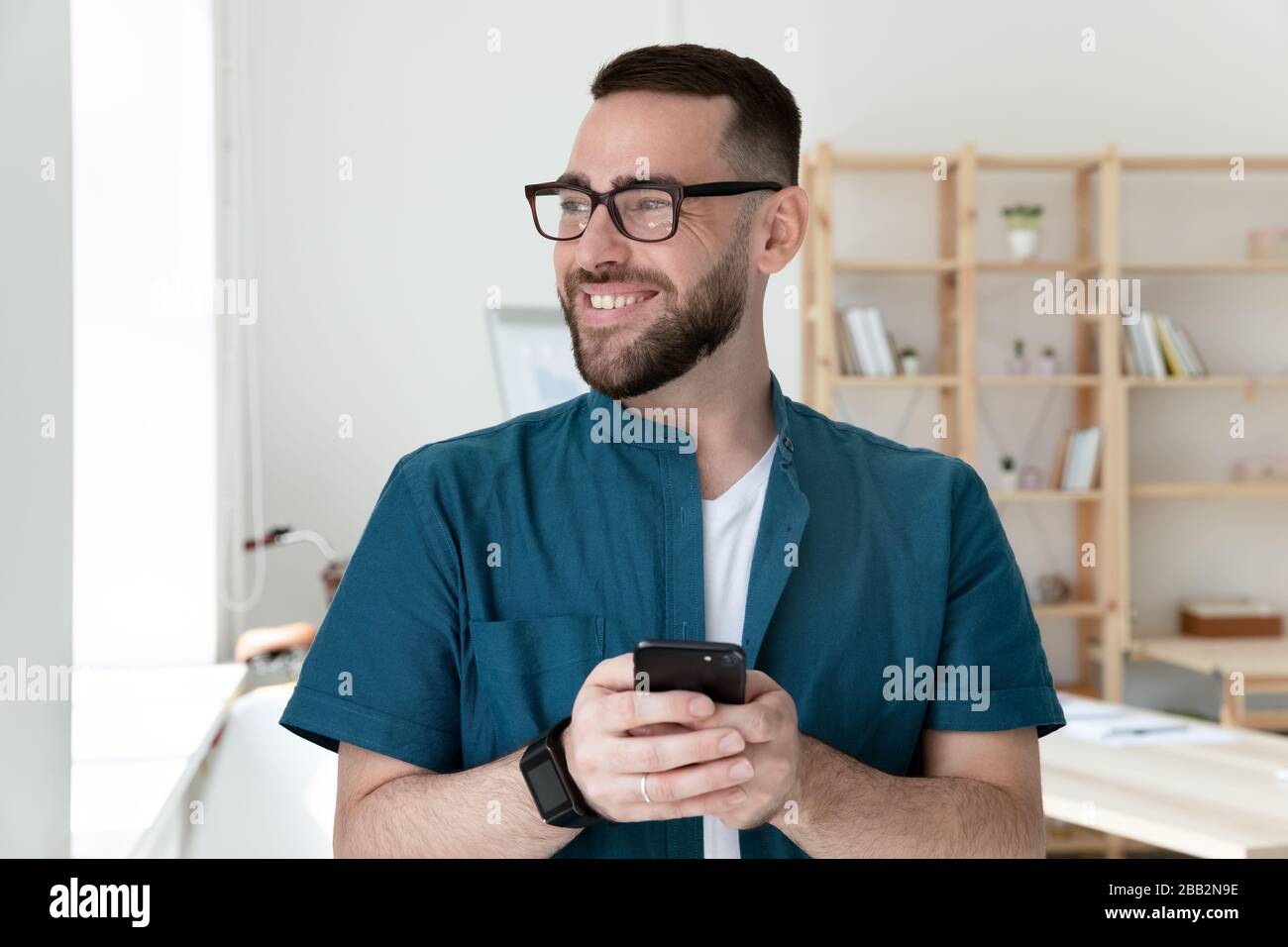 Happy male worker look in distance planning success Stock Photo - Alamy