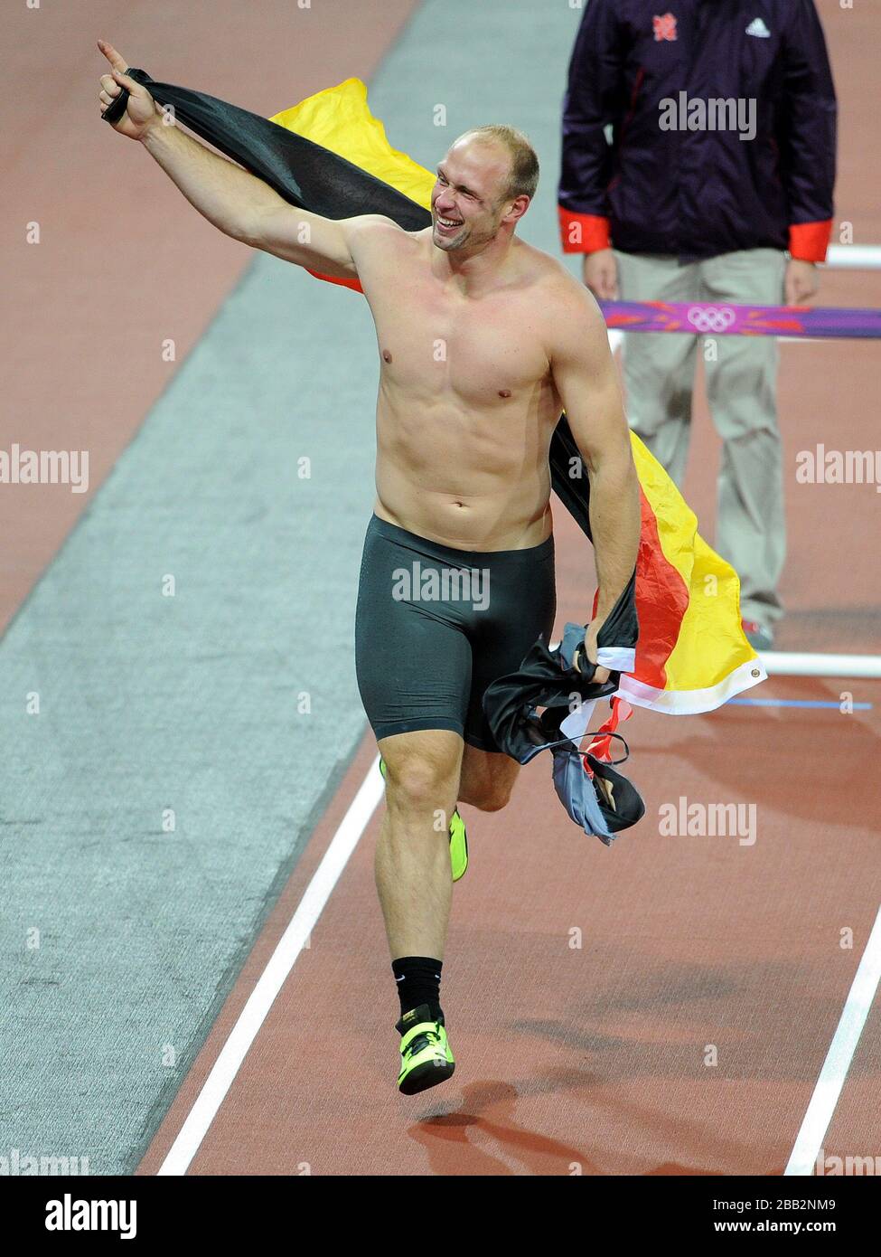 Germany's Robert Harting celebrates gold in the discus by hurdling down ...