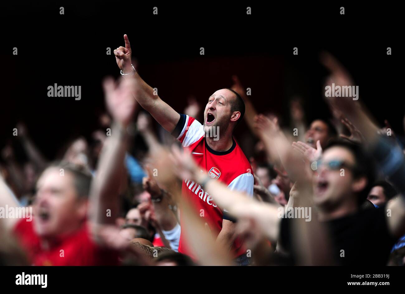 An Arsenal fan celebrates in the stands Stock Photo - Alamy