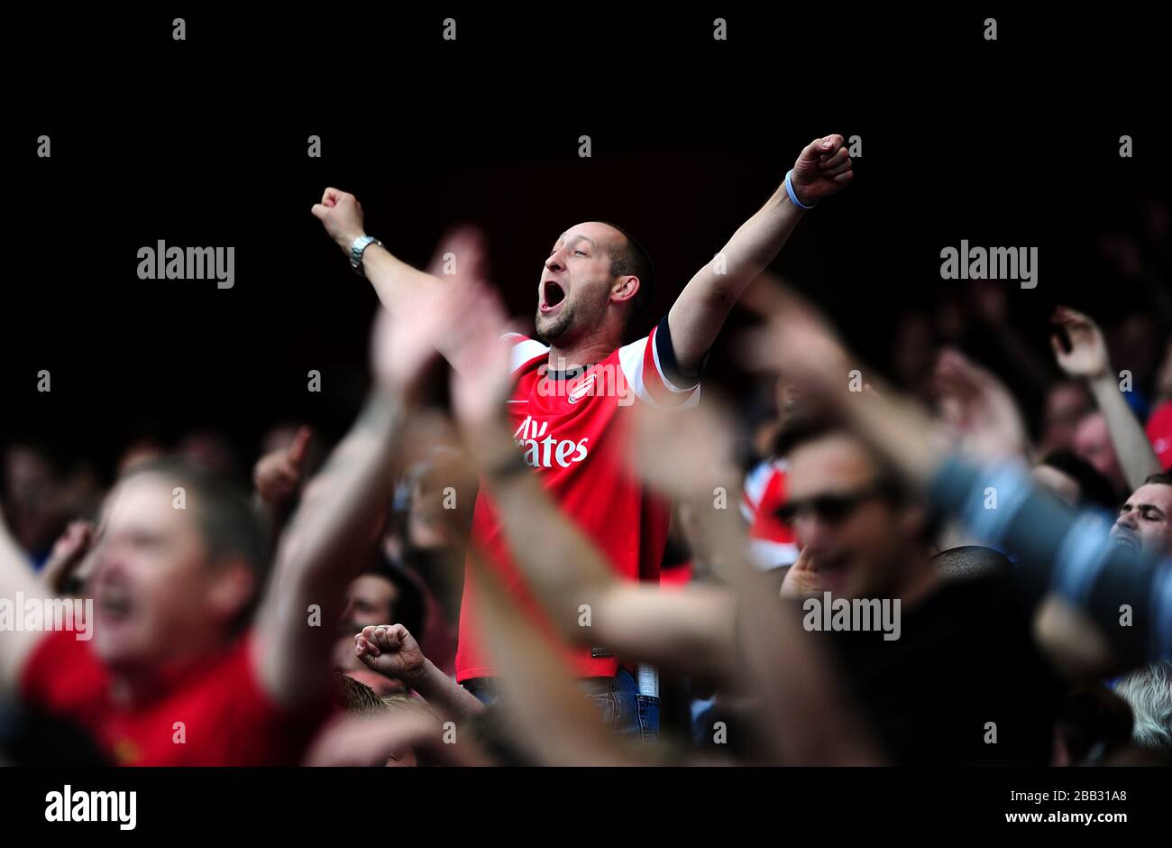 An Arsenal fan celebrates in the stands Stock Photo - Alamy