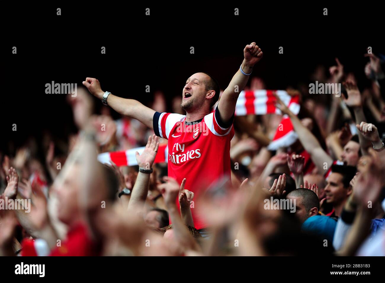 An Arsenal fan celebrates in the stands Stock Photo - Alamy