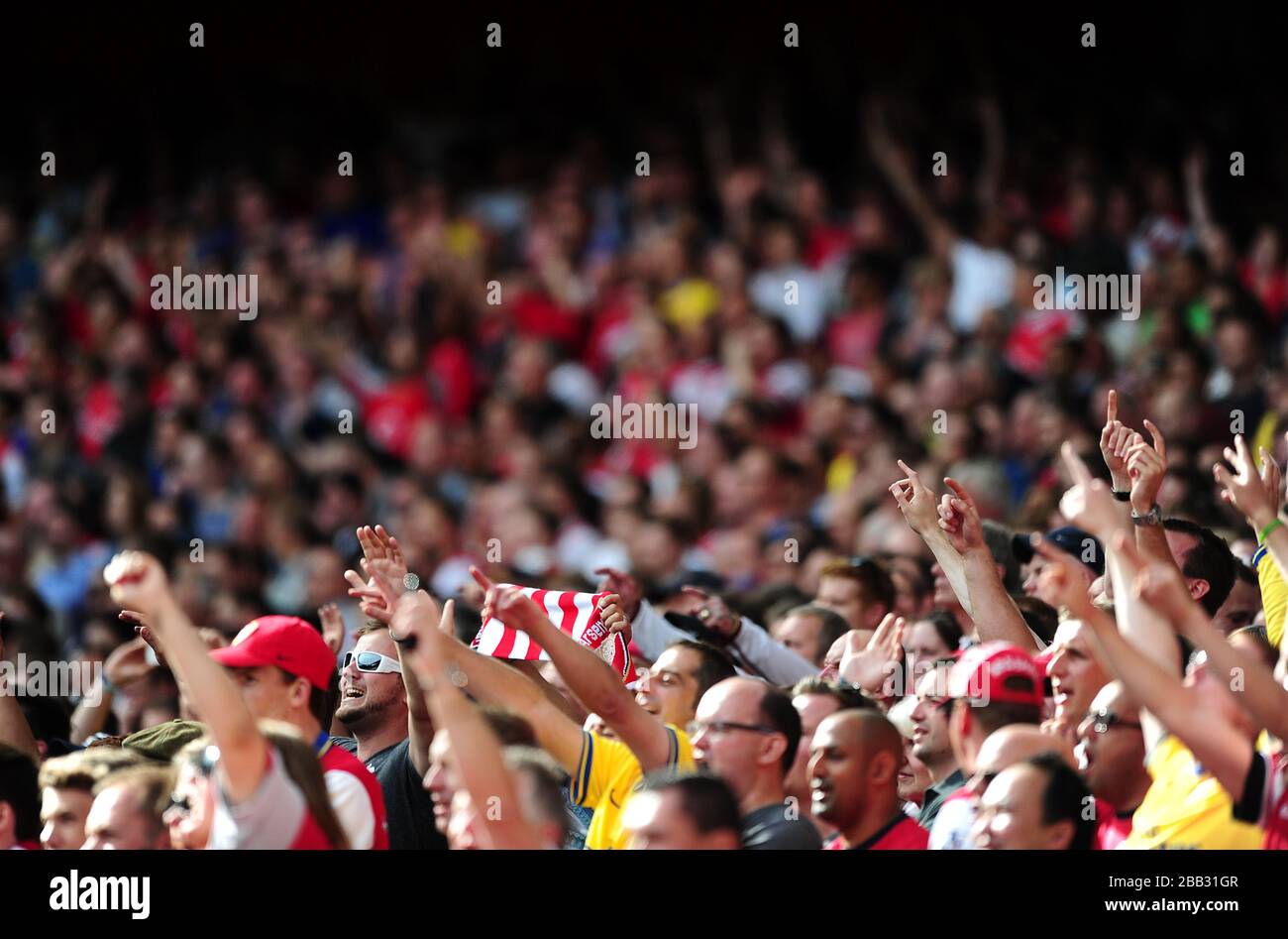 Arsenal fans in the stands Stock Photo - Alamy