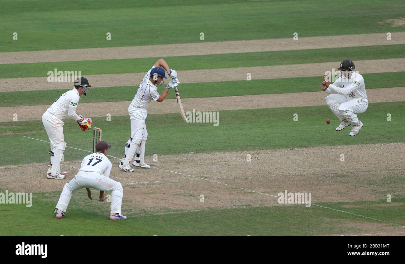 Middlesex's Neil Dexter hits the ball as Surrey's Vikram Solanki (far ...