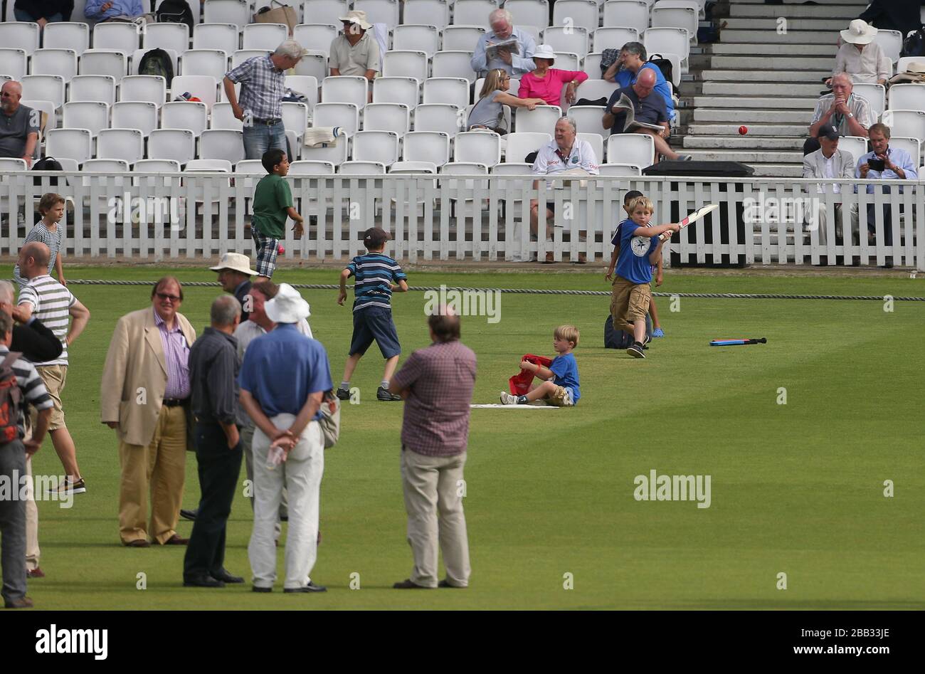 Spectators play cricket on the outfield during lunch Stock Photo - Alamy