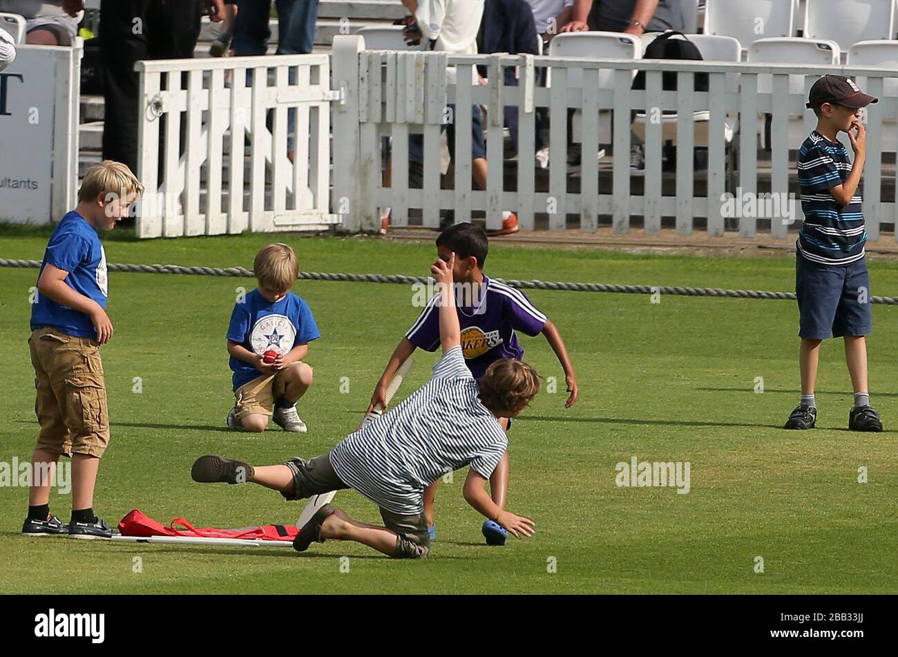 Spectators play cricket on the outfield during lunch Stock Photo - Alamy