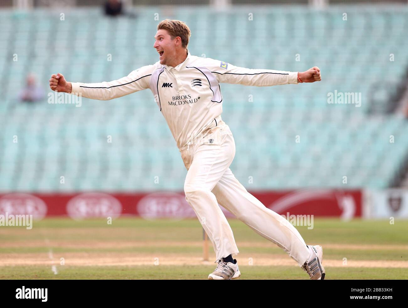 Middlesex's Ollie Rayner celebrates taking the wicket of Surrey's Jade ...