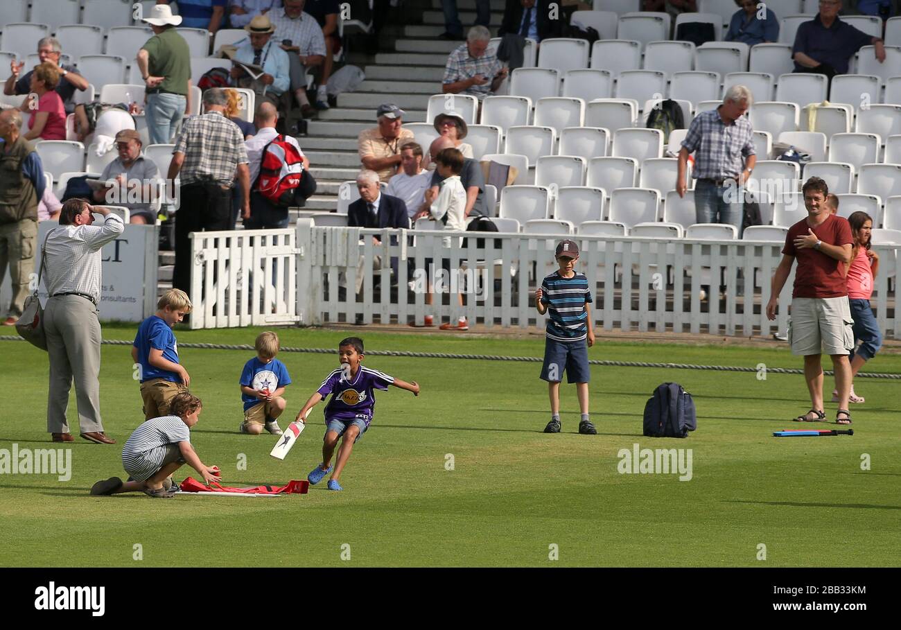 Spectators play cricket on the outfield during lunch Stock Photo - Alamy