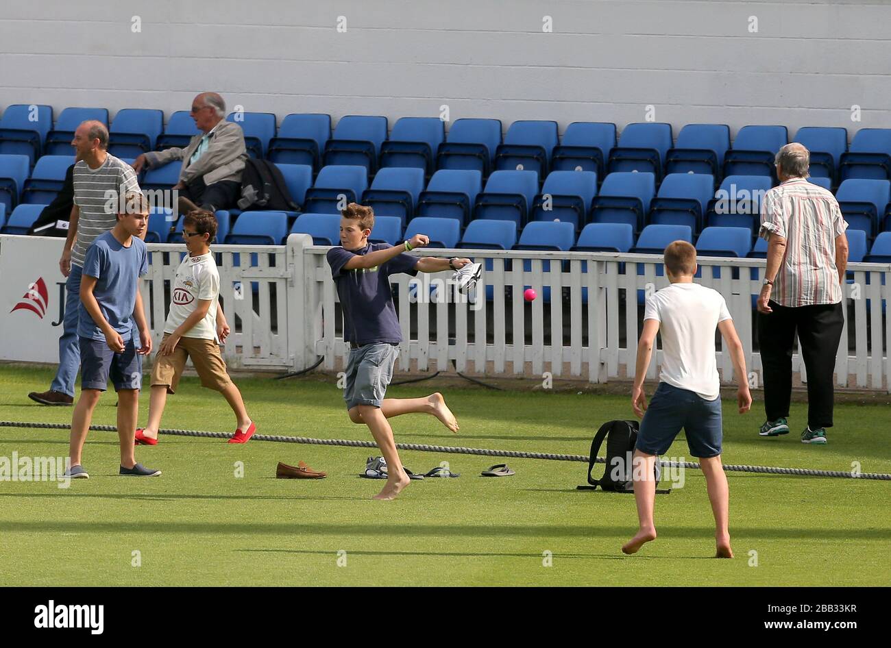 Spectators play cricket on the outfield during lunch Stock Photo - Alamy