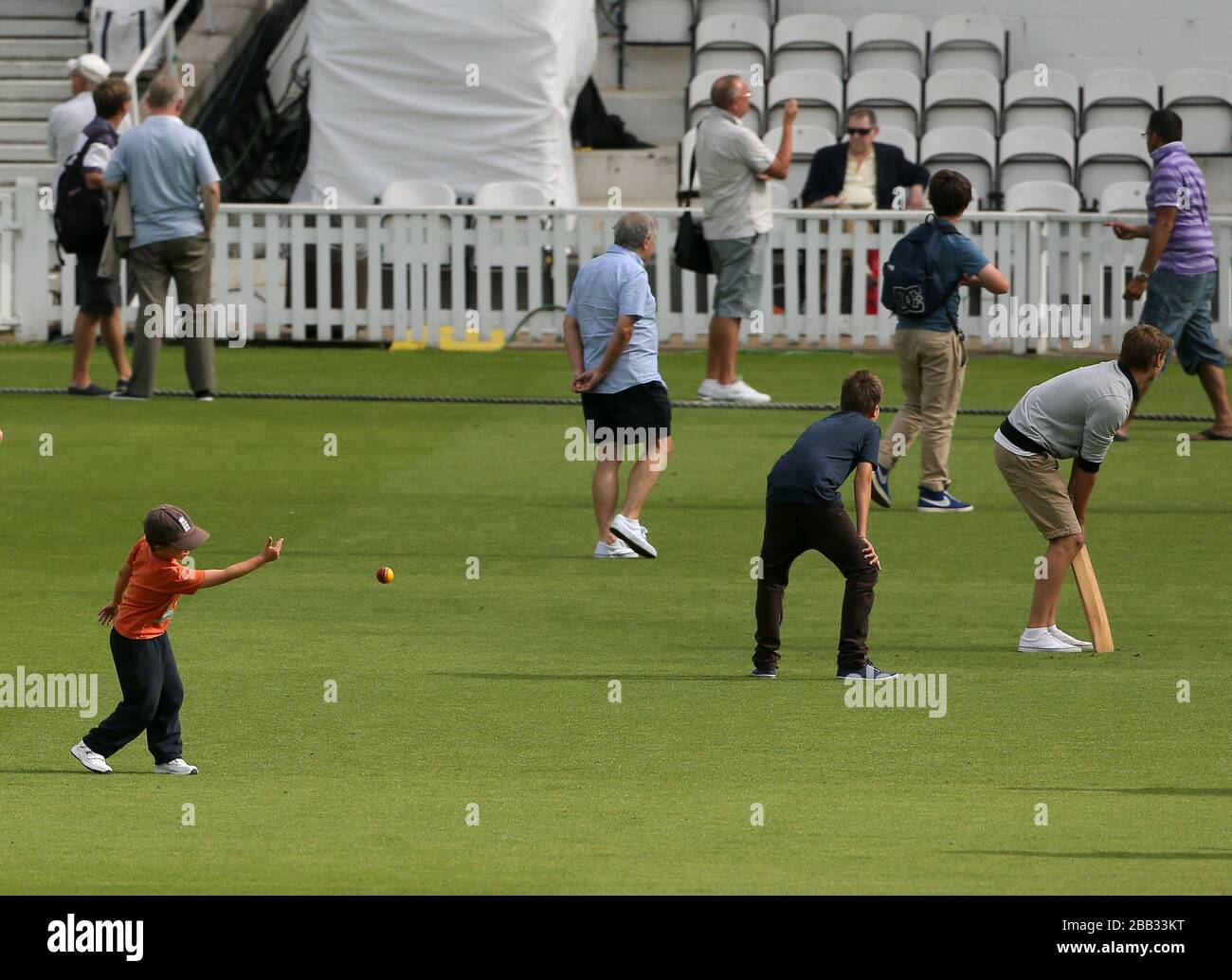Spectators play cricket on the outfield during lunch Stock Photo - Alamy