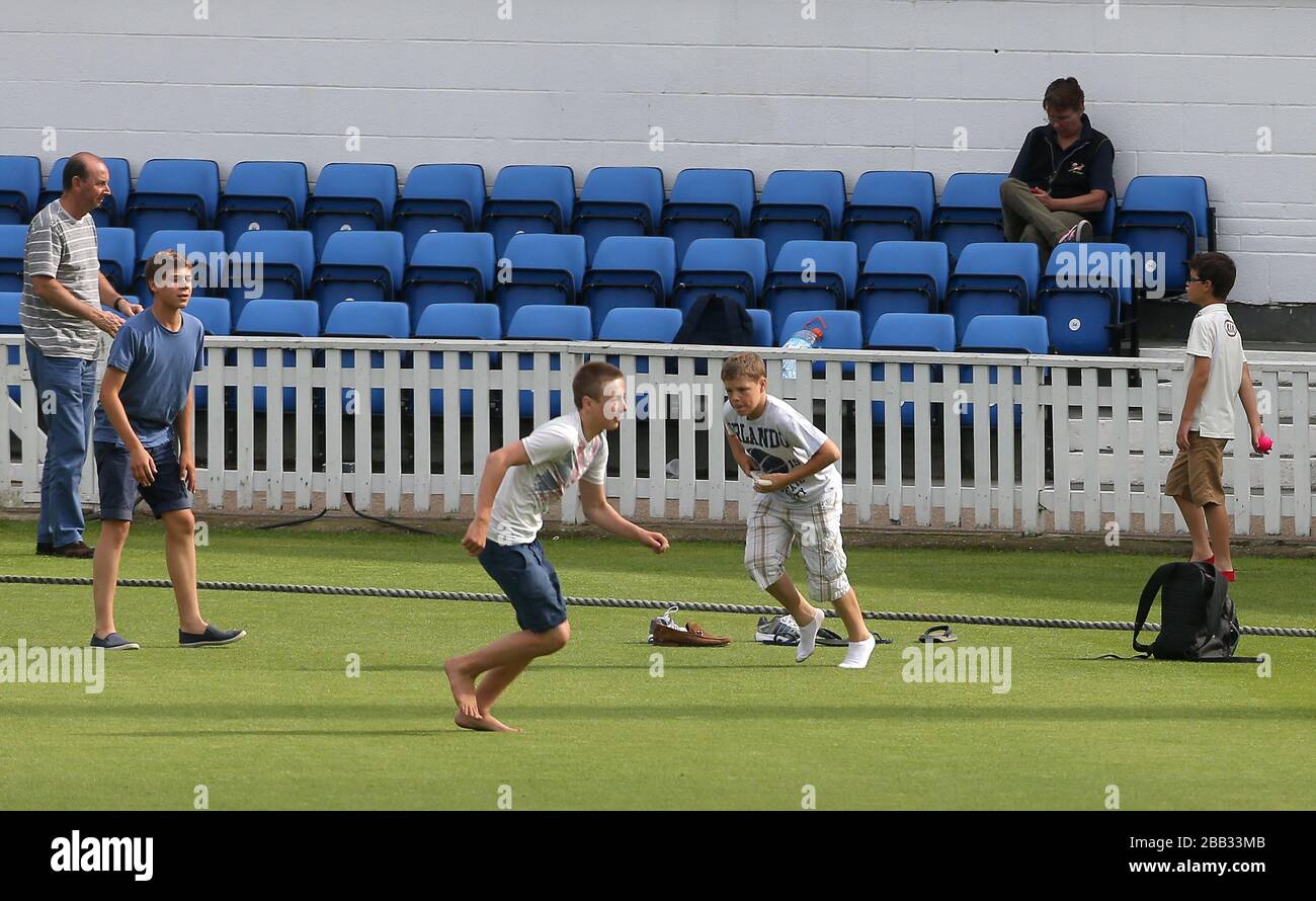 Spectators play cricket on the outfield during lunch Stock Photo - Alamy