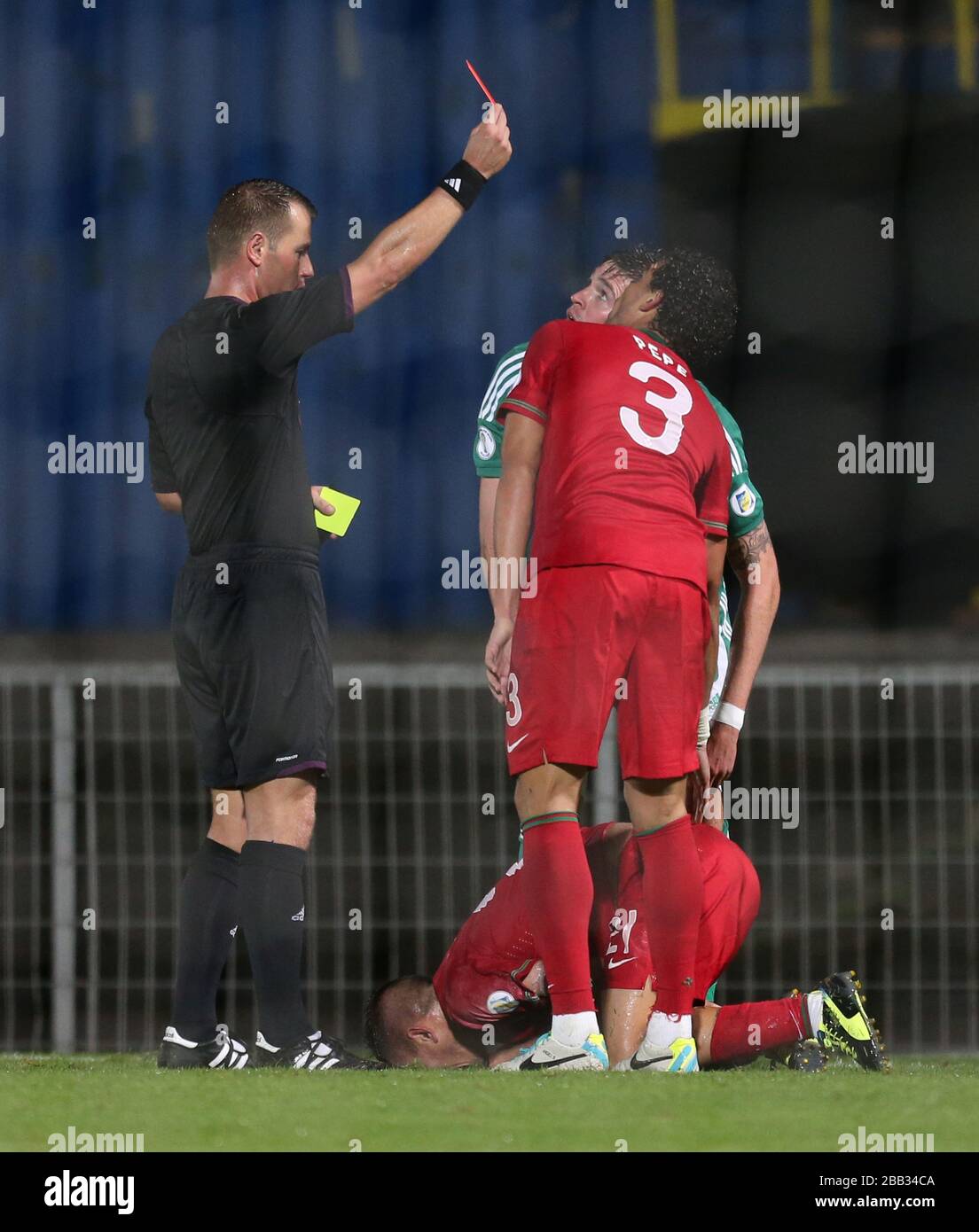 Northern Ireland's Kyle Lafferty is shown a red card by referee Danny ...
