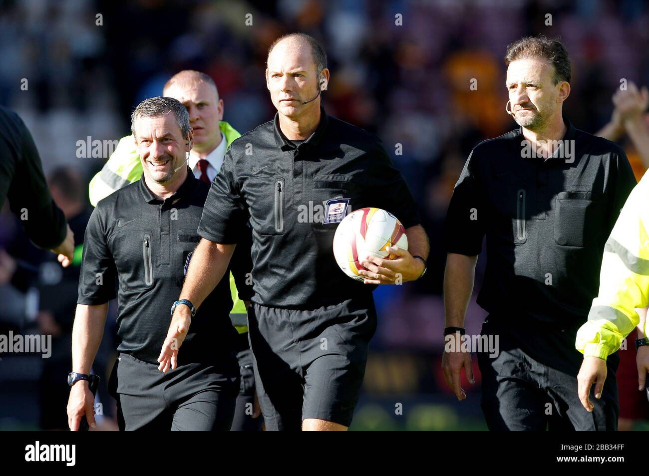 Referee Andy Haines (centre) leaves the pitch with his assistants Stock ...