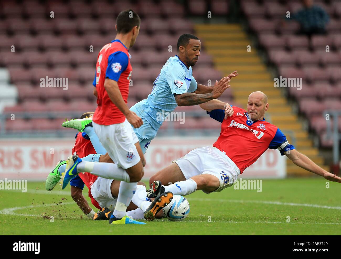 Coventry City's Callum Wilson (centre) tangles with Gillingham's Leon ...