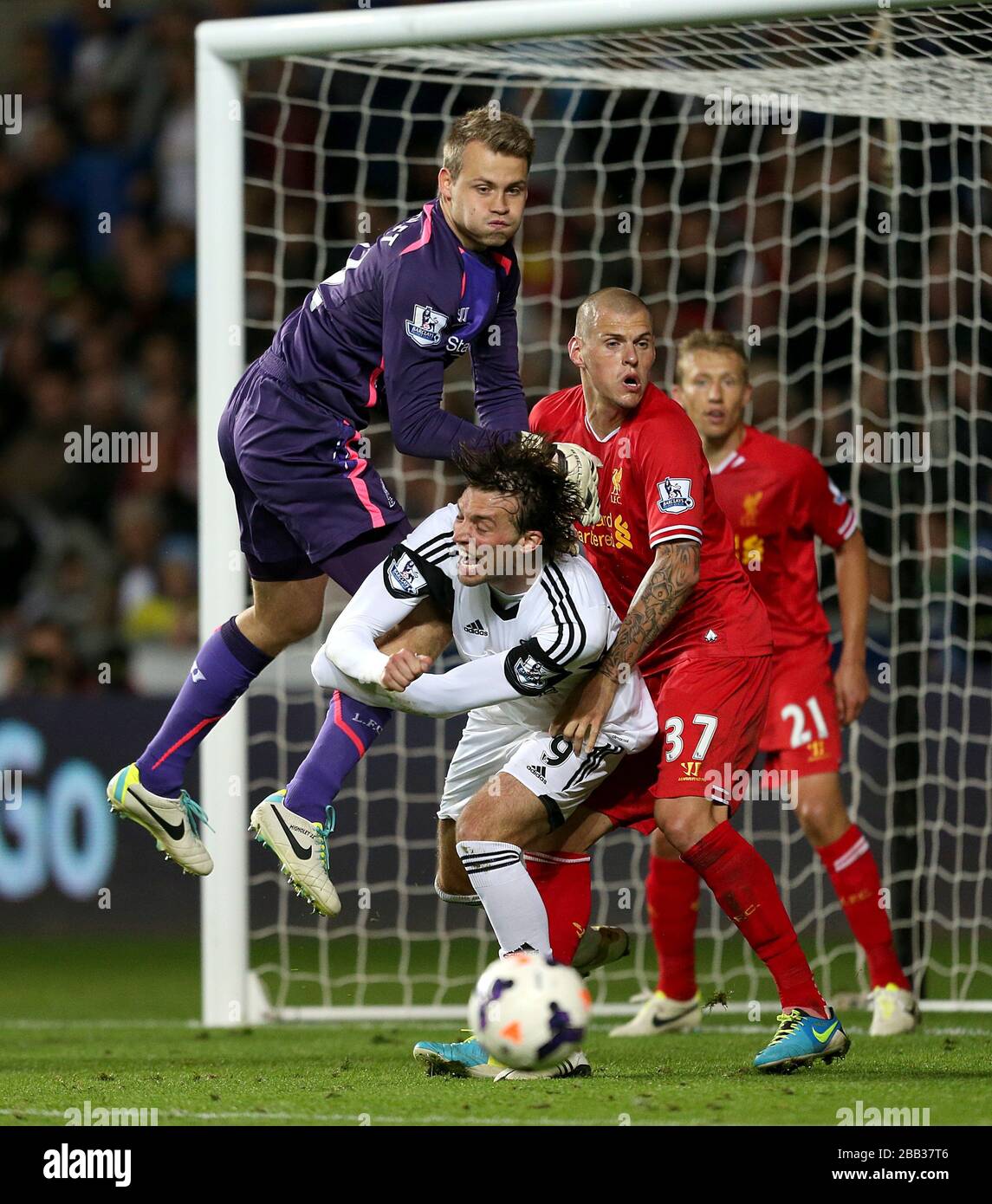 Liverpool goalkeeper Simon Mignolet (left) collides with Swansea City's ...