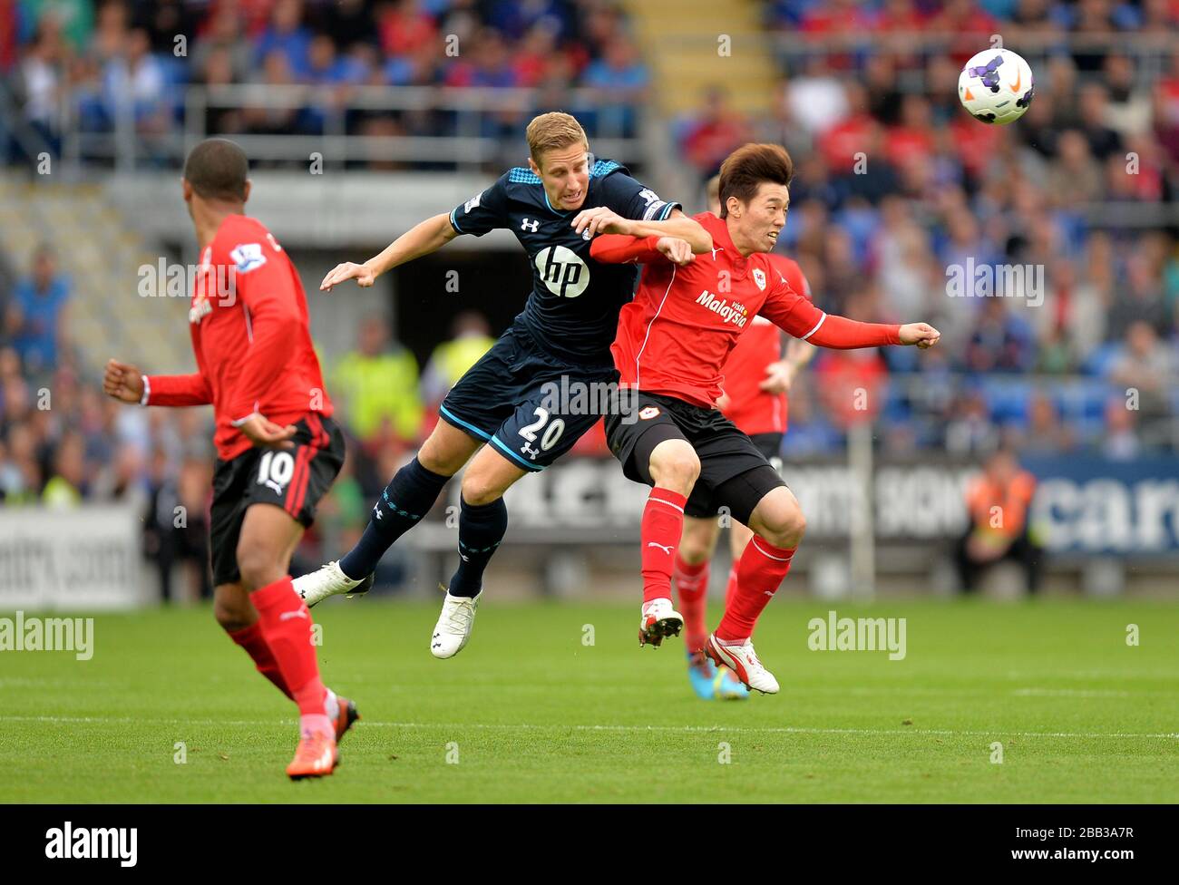 Tottenham Hotspur's Michael Dawson (left) and Cardiff City's Kim Bo ...