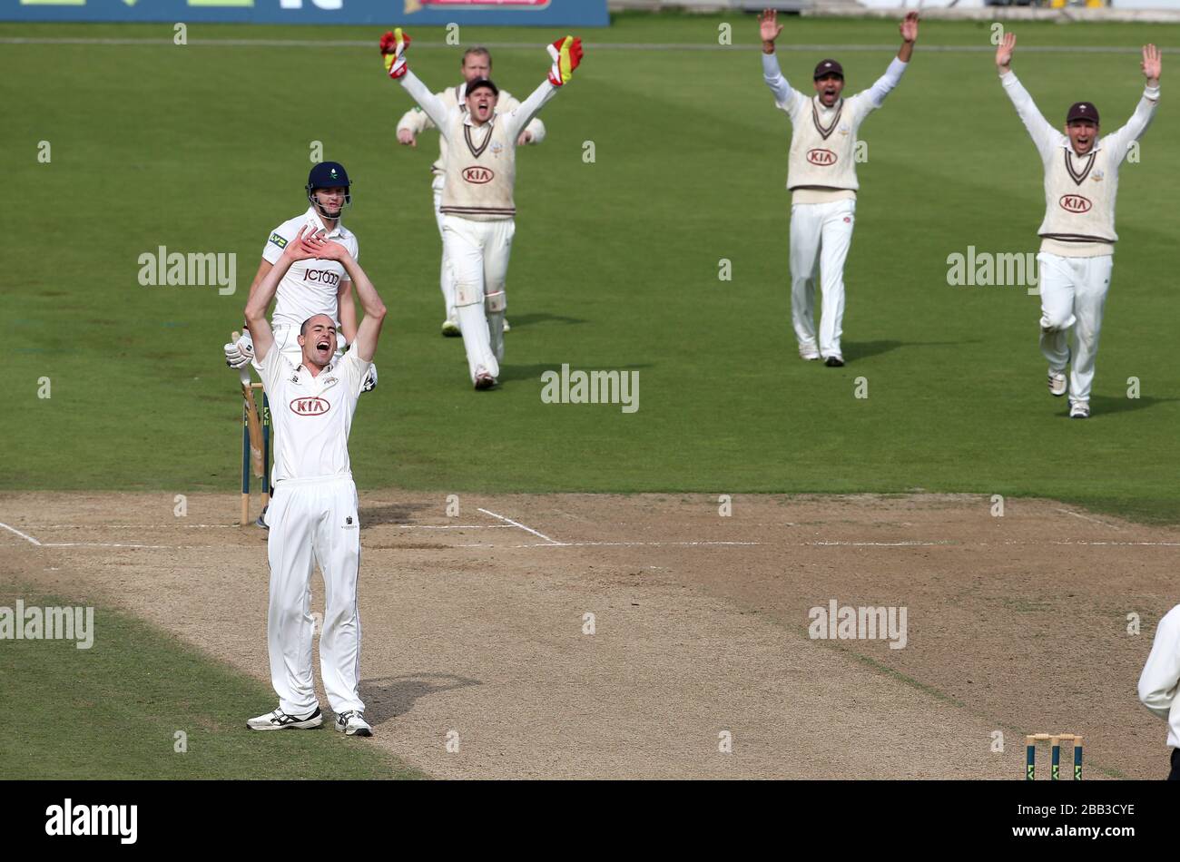 Surrey's Timothy Linley (left) celebrates taking the wicket of ...