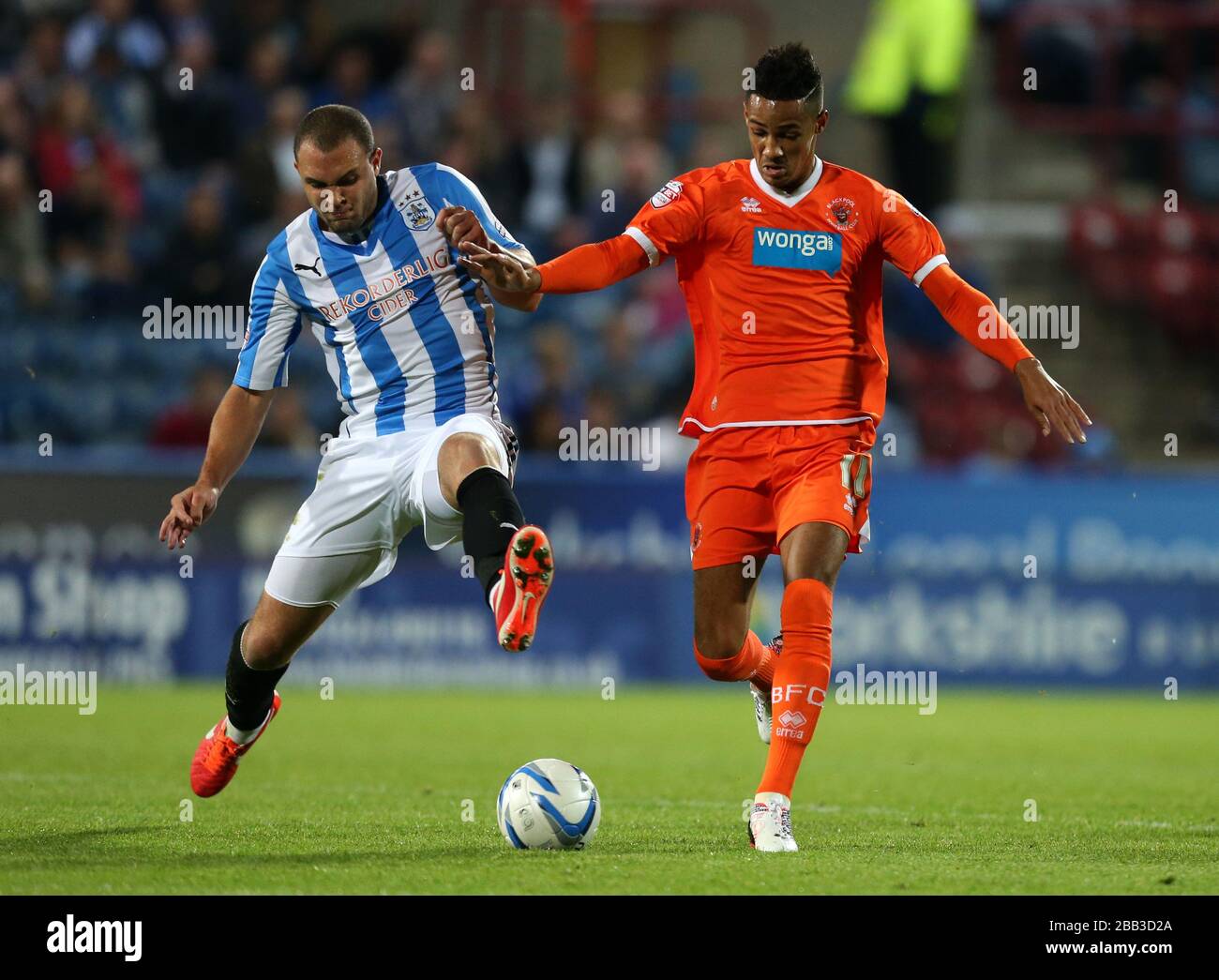 Huddersfield Town's Joel Lynch and Blackpool's Tom Ince battle for the ...