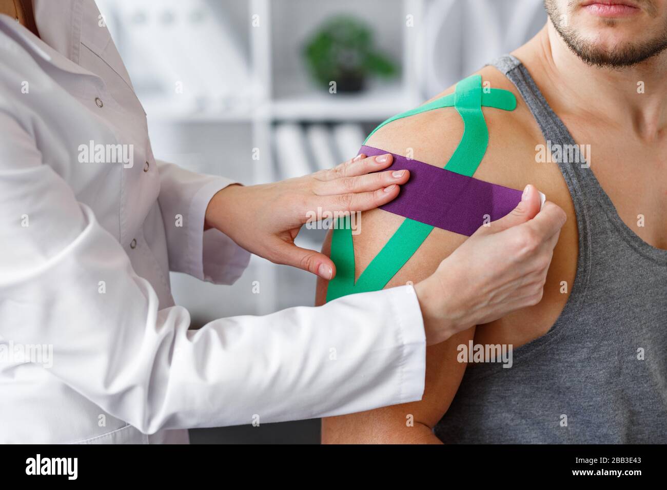 Kinesiology taping. Physical therapist applying kinesiology tape Stock ...