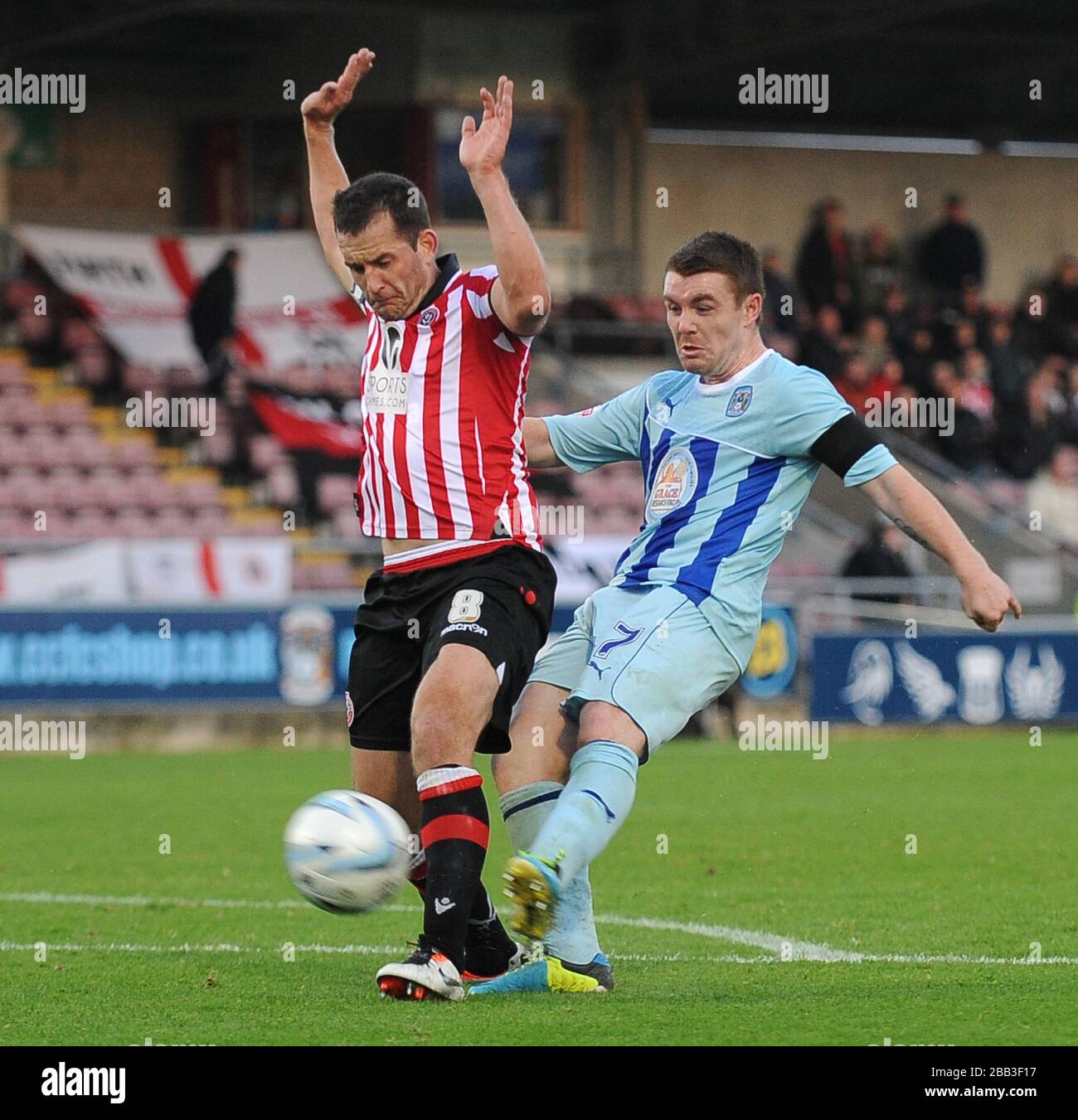 Coventry City's John Fleck (right) has a shot on goal under pressure ...