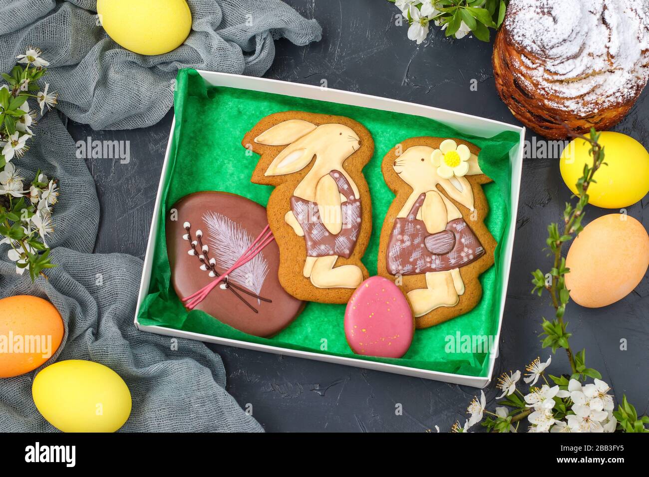 Easter gingerbread in the form of cute rabbits and eggs in a box on a ...