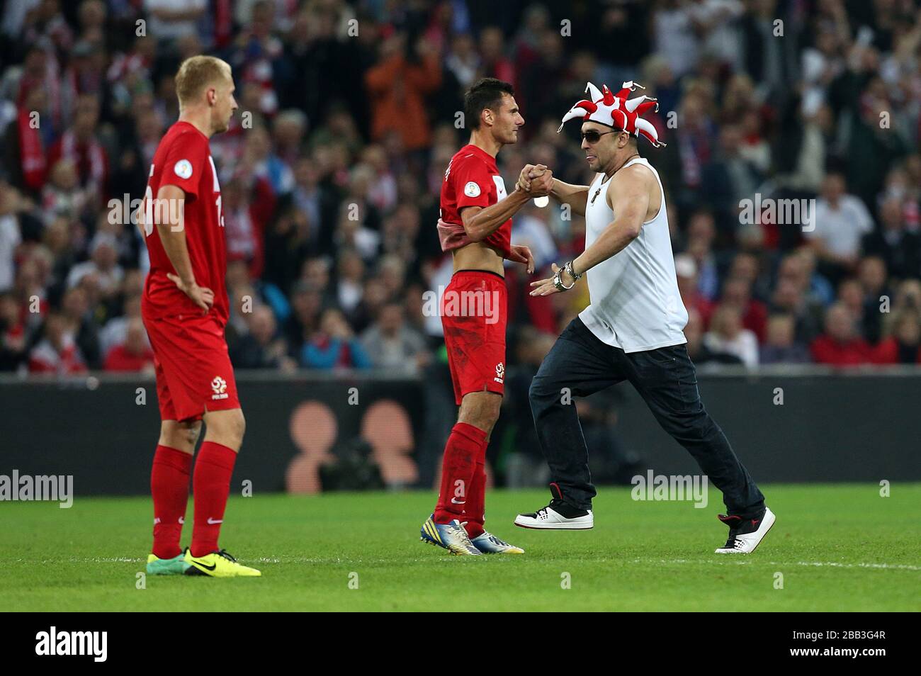 A pitch invader runs onto the pitch Stock Photo - Alamy