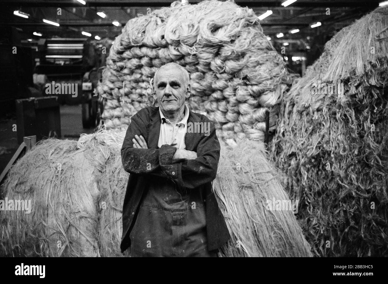 A worker leaning against bales of jute at Tay Spinners mill in Dundee ...
