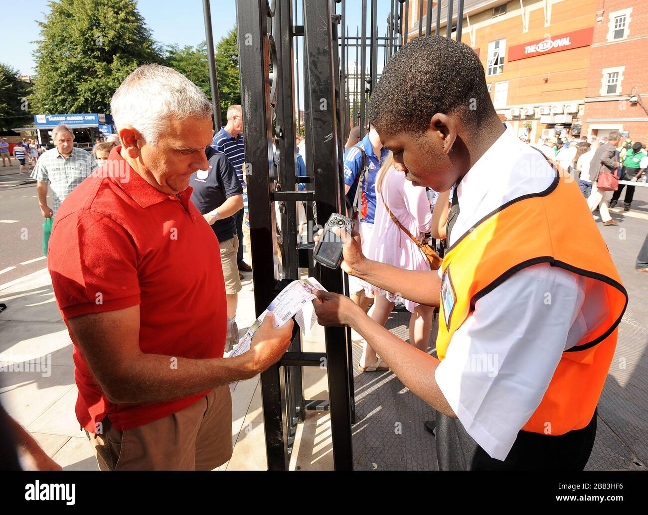 Fans have their tickets barcode scanned by a steward on the way in to ...
