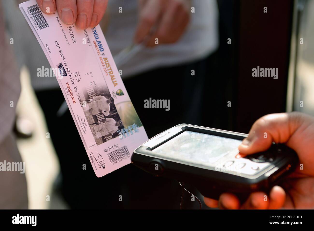 Fans have their tickets barcode scanned by a steward on the way in to ...