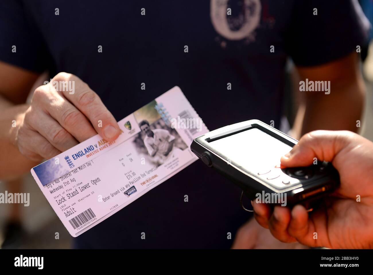 Fans have their tickets barcode scanned by a steward on the way in to ...