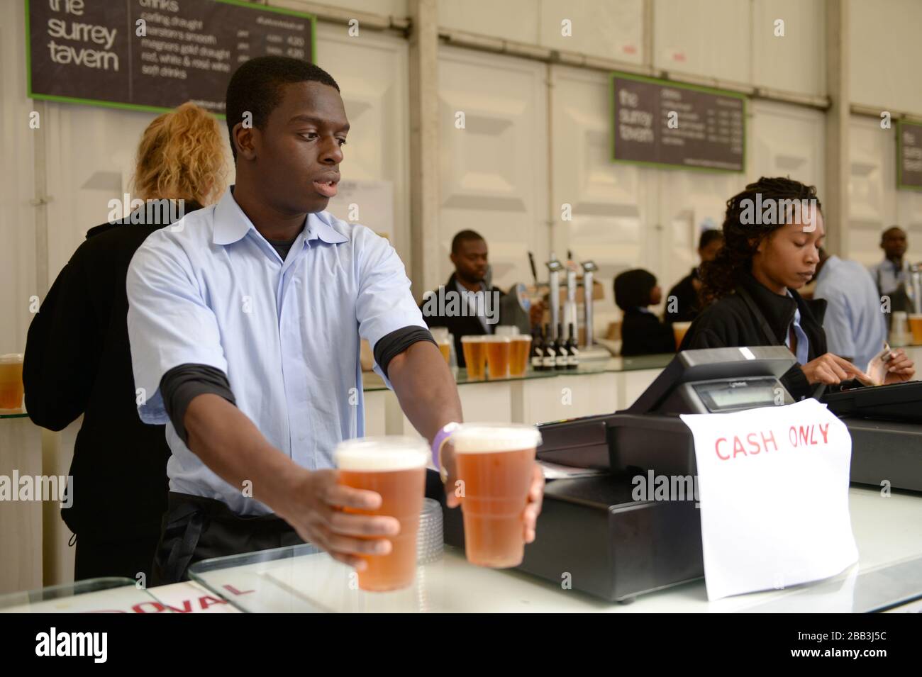 Bar staff at work at the Kia Oval Stock Photo - Alamy